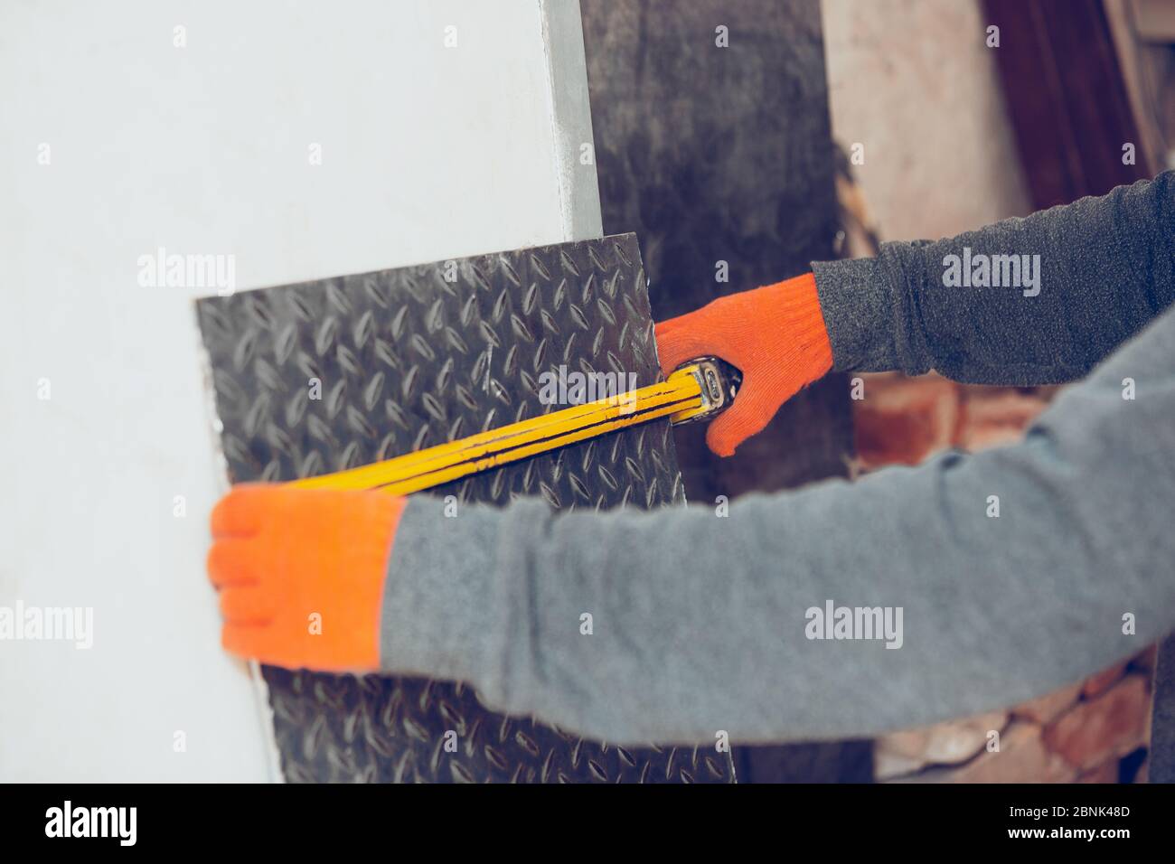 Closeup of repairman in uniform, professional builder working using ...