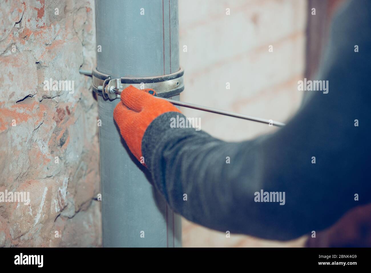 Closeup of repairman in uniform, professional builder working using ...