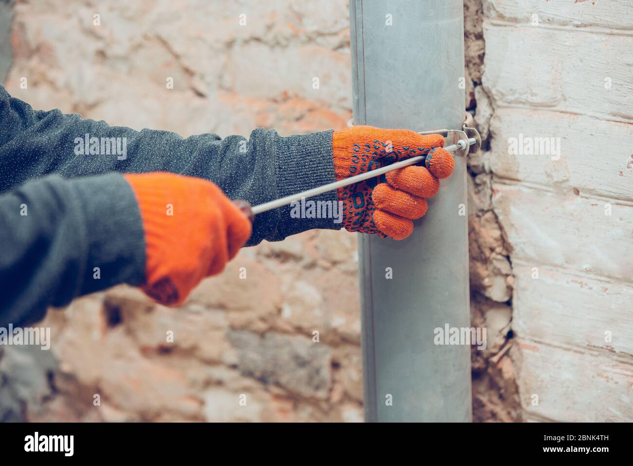Closeup of repairman in uniform, professional builder working using ...