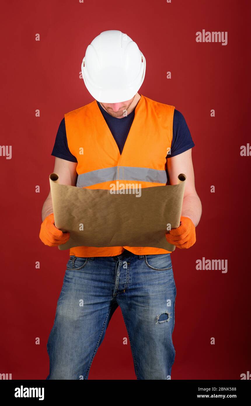 Builder looks at plan for new home. Engineer, architect, labourer ...