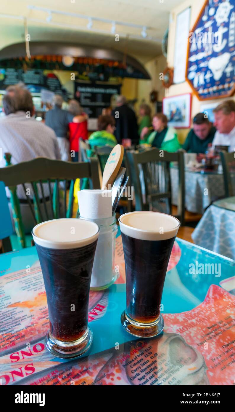 Two halves of Guinness in restaurant, Dingle Village, Dingle Peninsula ...