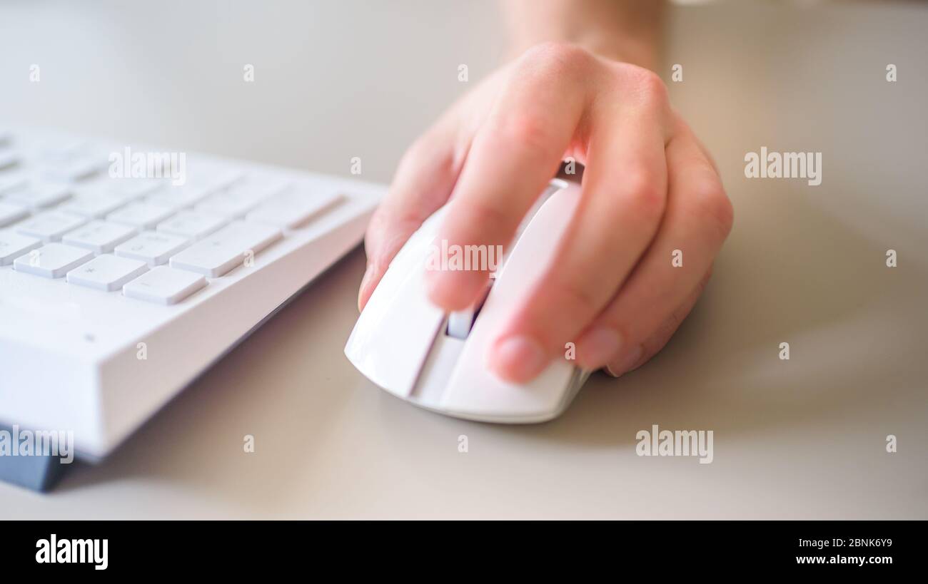 close up hand business man using mouse and laptop in office with ...