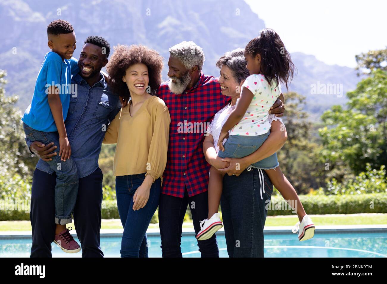 Multi-generation mixed race family enjoying their time at a garden ...