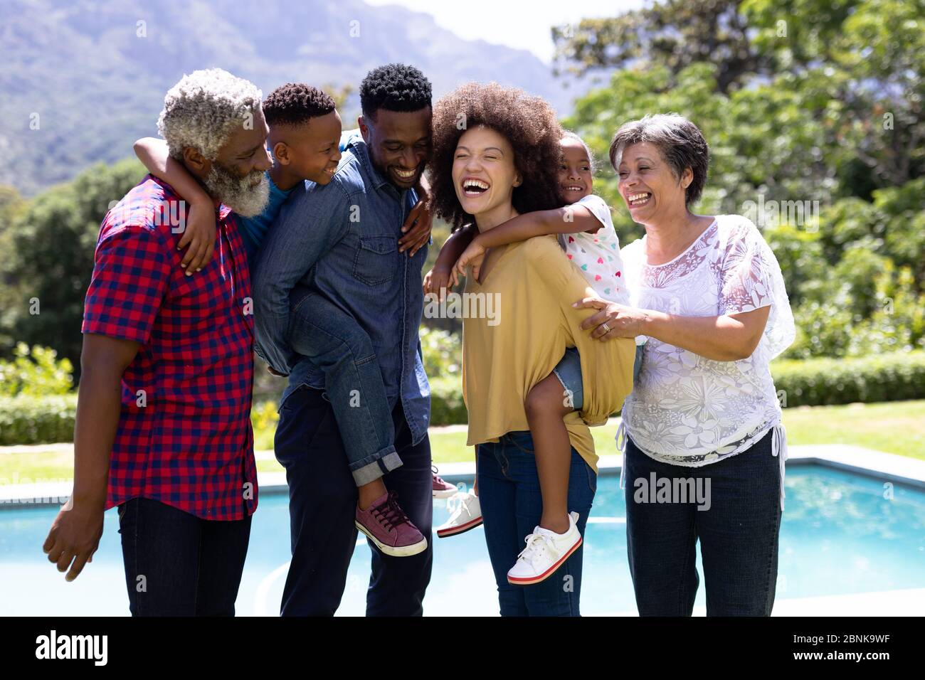 Multi-generation mixed race family enjoying their time at a garden ...