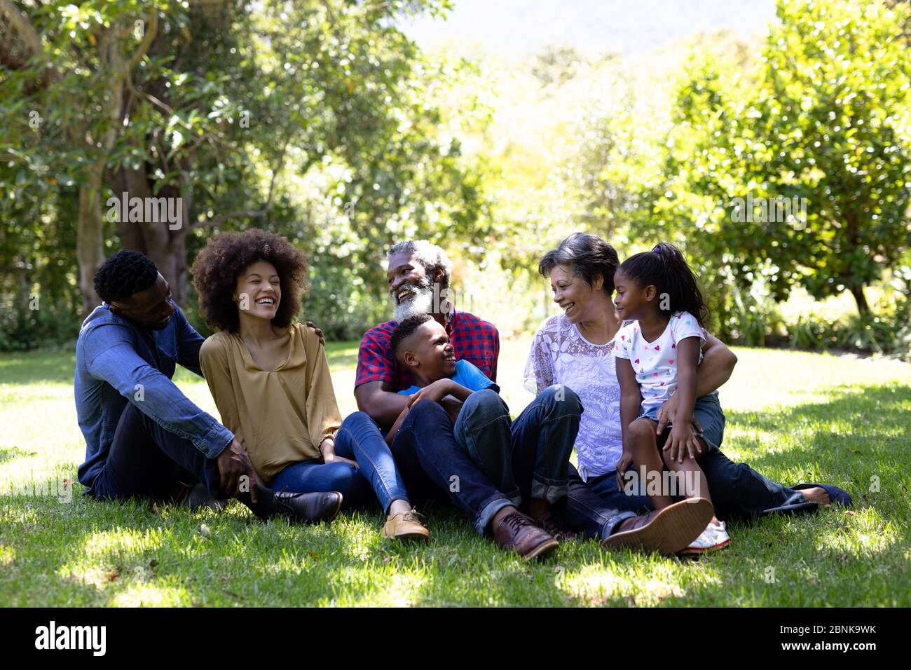 Multi-generation mixed race family enjoying their time at a garden ...