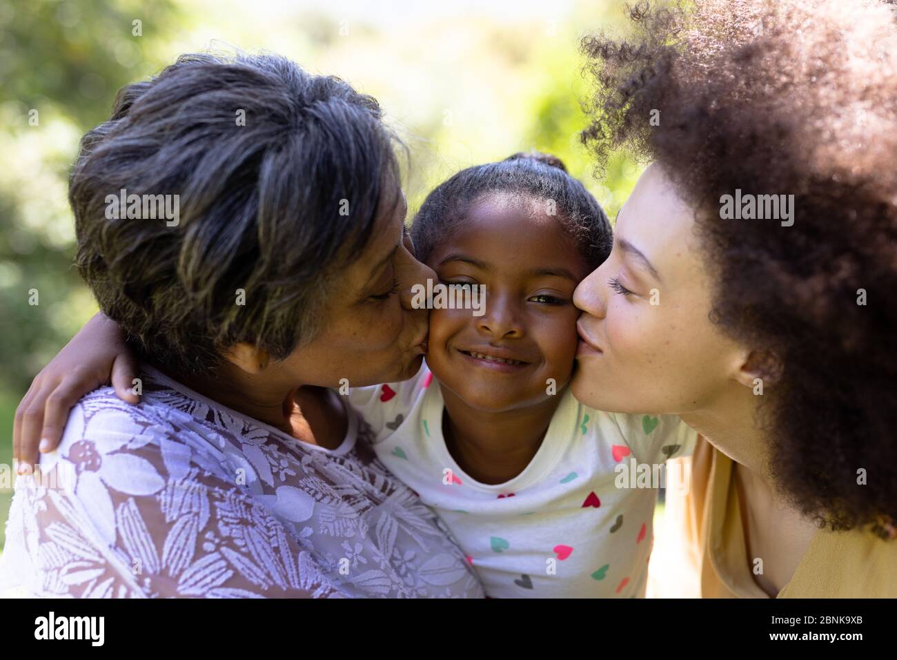 Multi-generation mixed race family enjoying their time at a garden ...