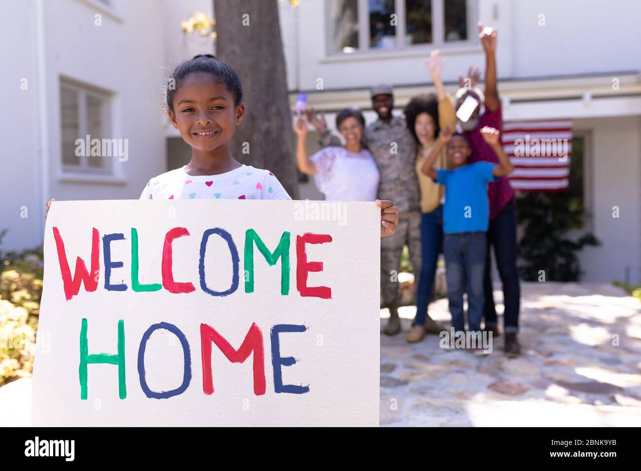 Multi-generation mixed race family welcoming an African American man ...