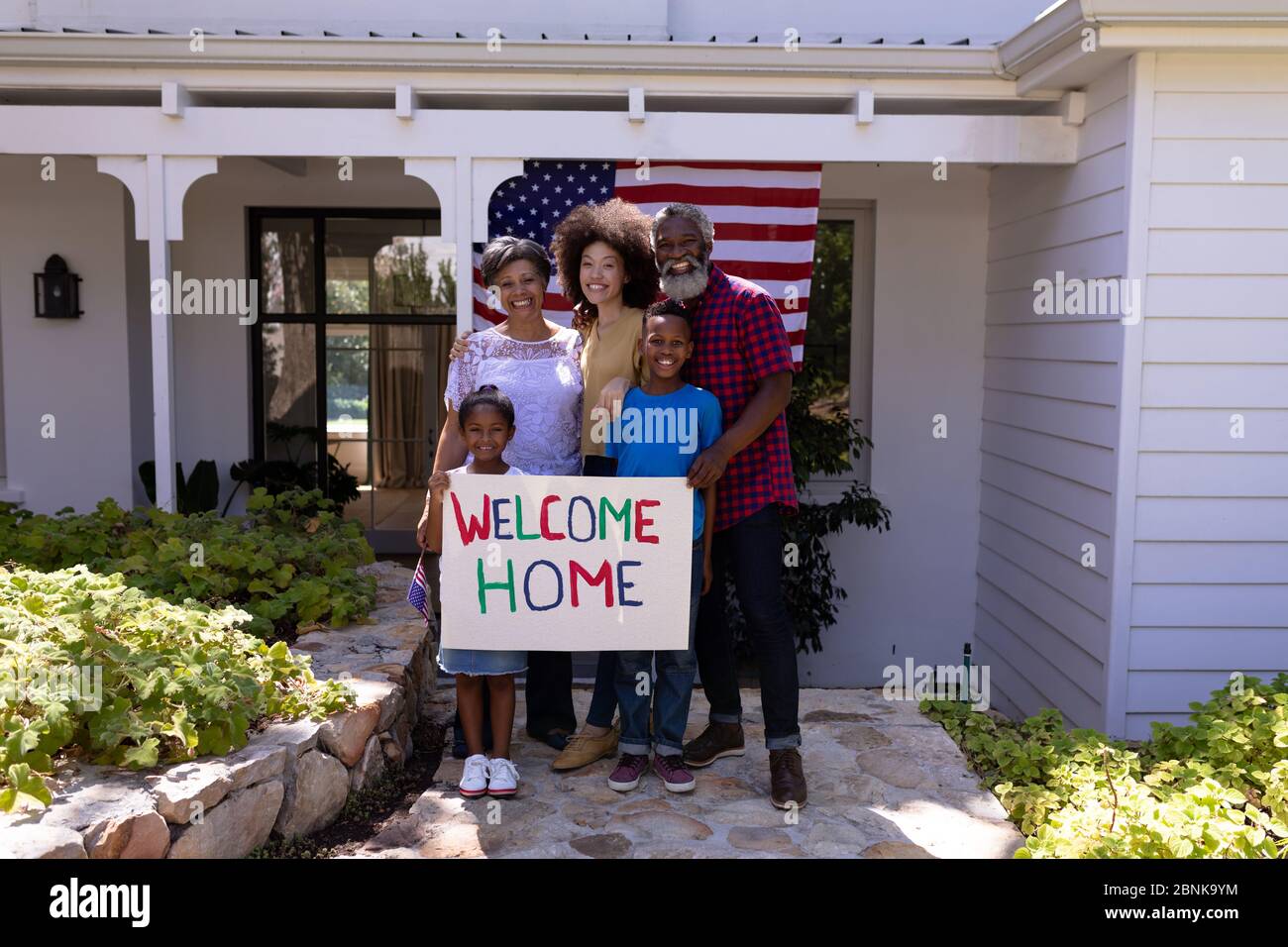 Multi-generation mixed race family welcoming an African American man ...