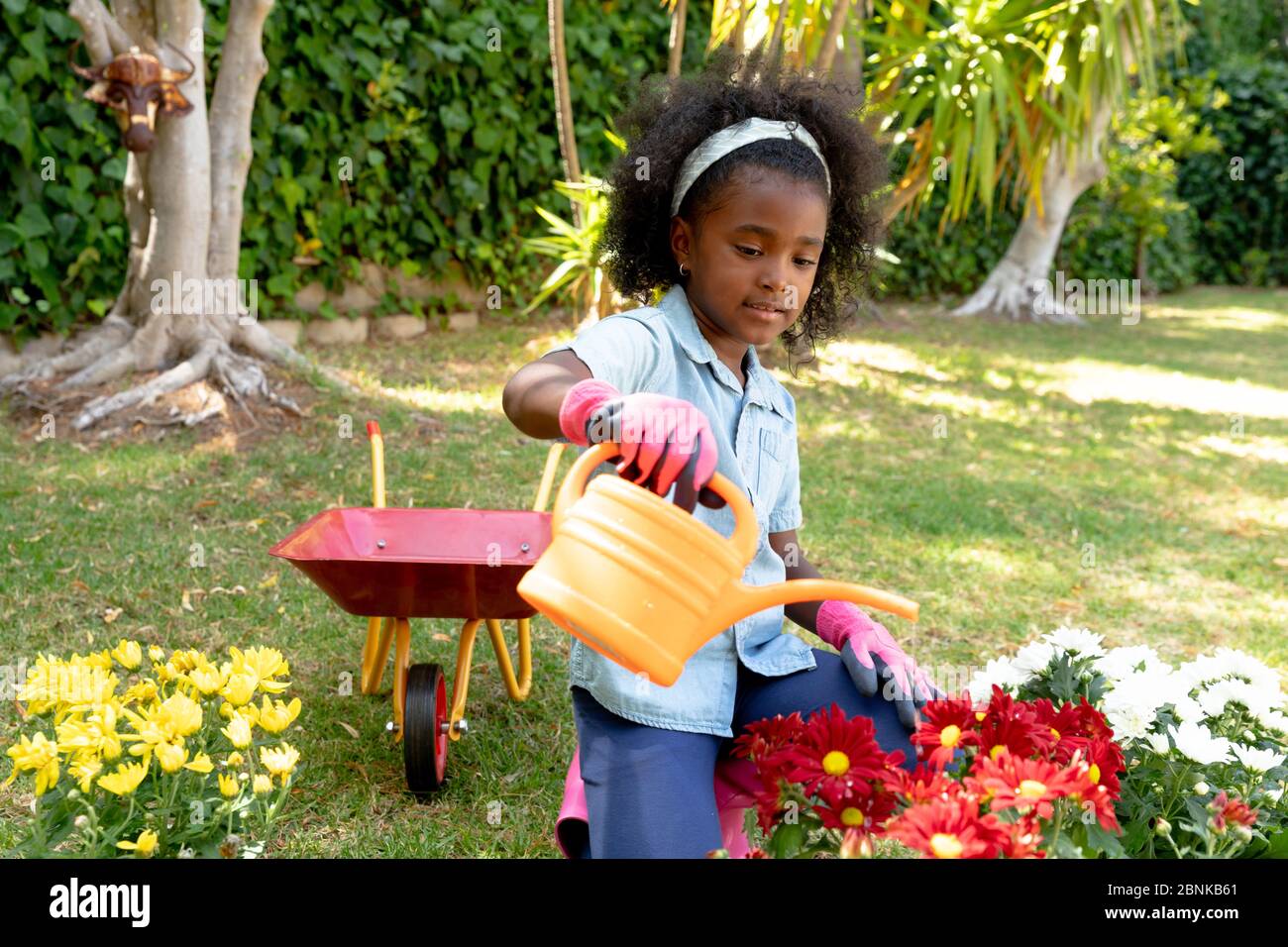 African American girl planting flowers Stock Photo - Alamy