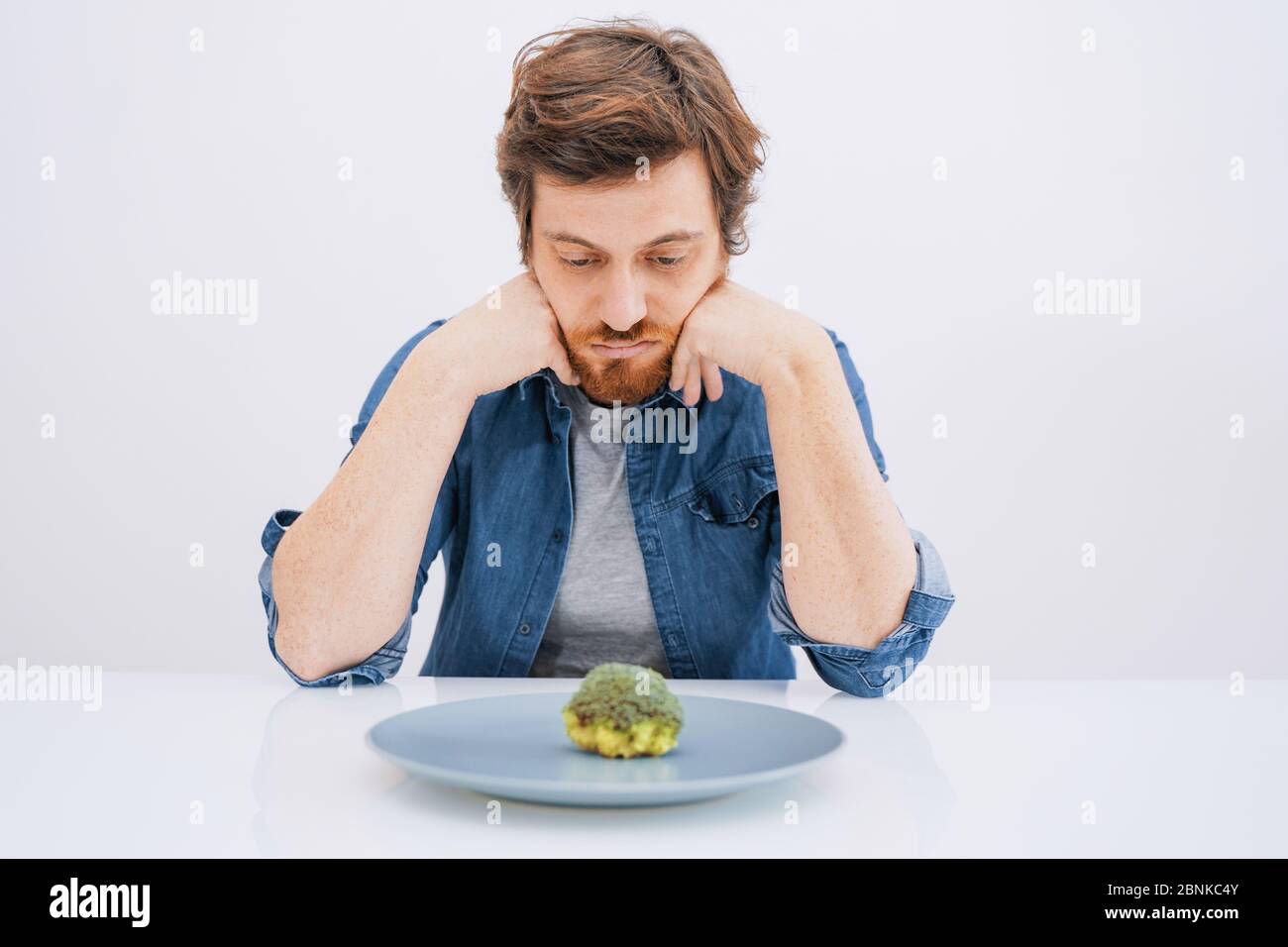 Man sad eating vegetables hi-res stock photography and images - Alamy
