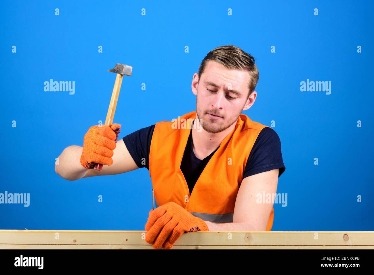 Handcrafting concept. Man, labourer, handyman in bright vest and ...