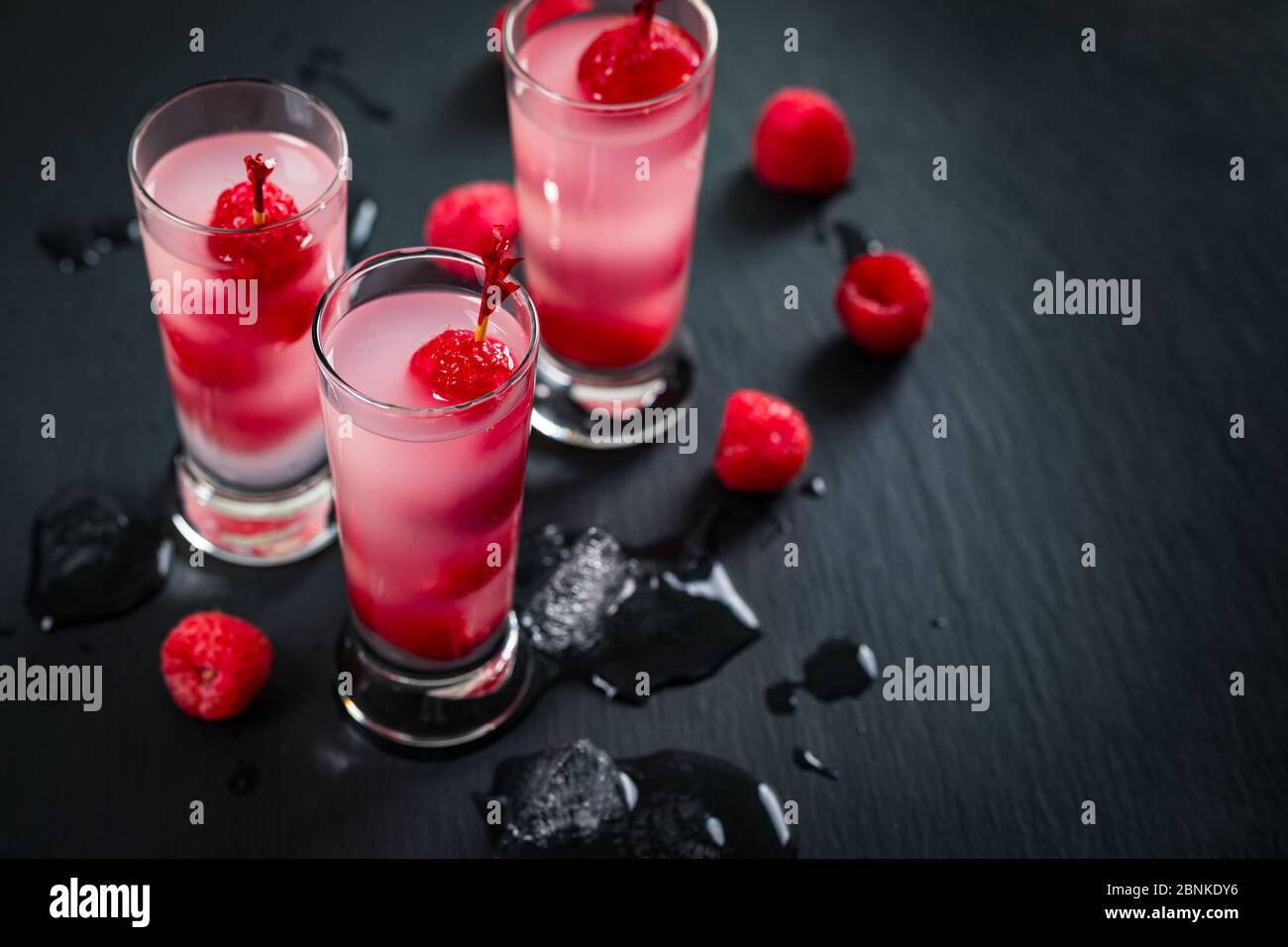 Raspberry Vodka Shots Cocktail with Fresh Raspberry on Black Background ...