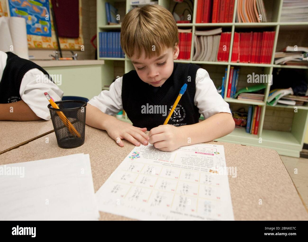 Austin Texas USA, January 2013: Second-grade boy wearing uniform uses a ...