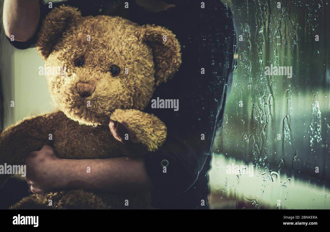 Sad child holding teddy bear hi-res stock photography and images - Alamy