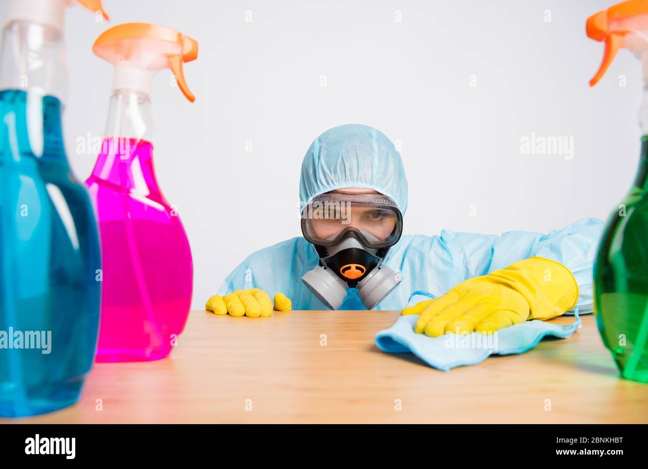 Portrait of focused tidy man disinfect desk use wiper rag chemical ...