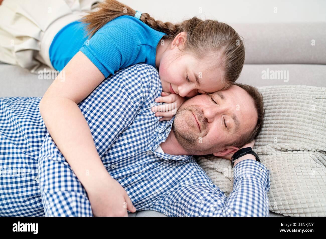 Father's love. Daughter hugs dad tired after work Stock Photo - Alamy