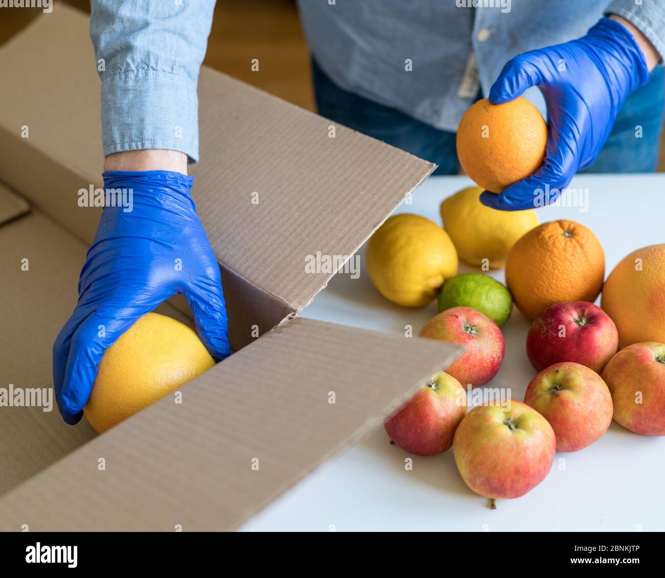 Hand in medical gloves packing hi-res stock photography and images - Alamy