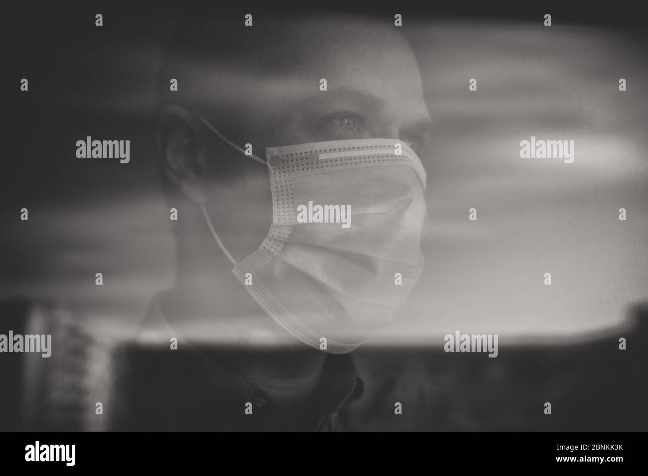 Man behind the window during self isolation. Stay home Stock Photo - Alamy