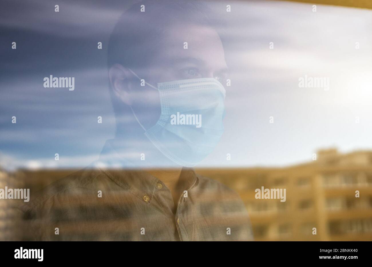 Man behind the window during self isolation. Stay home Stock Photo - Alamy