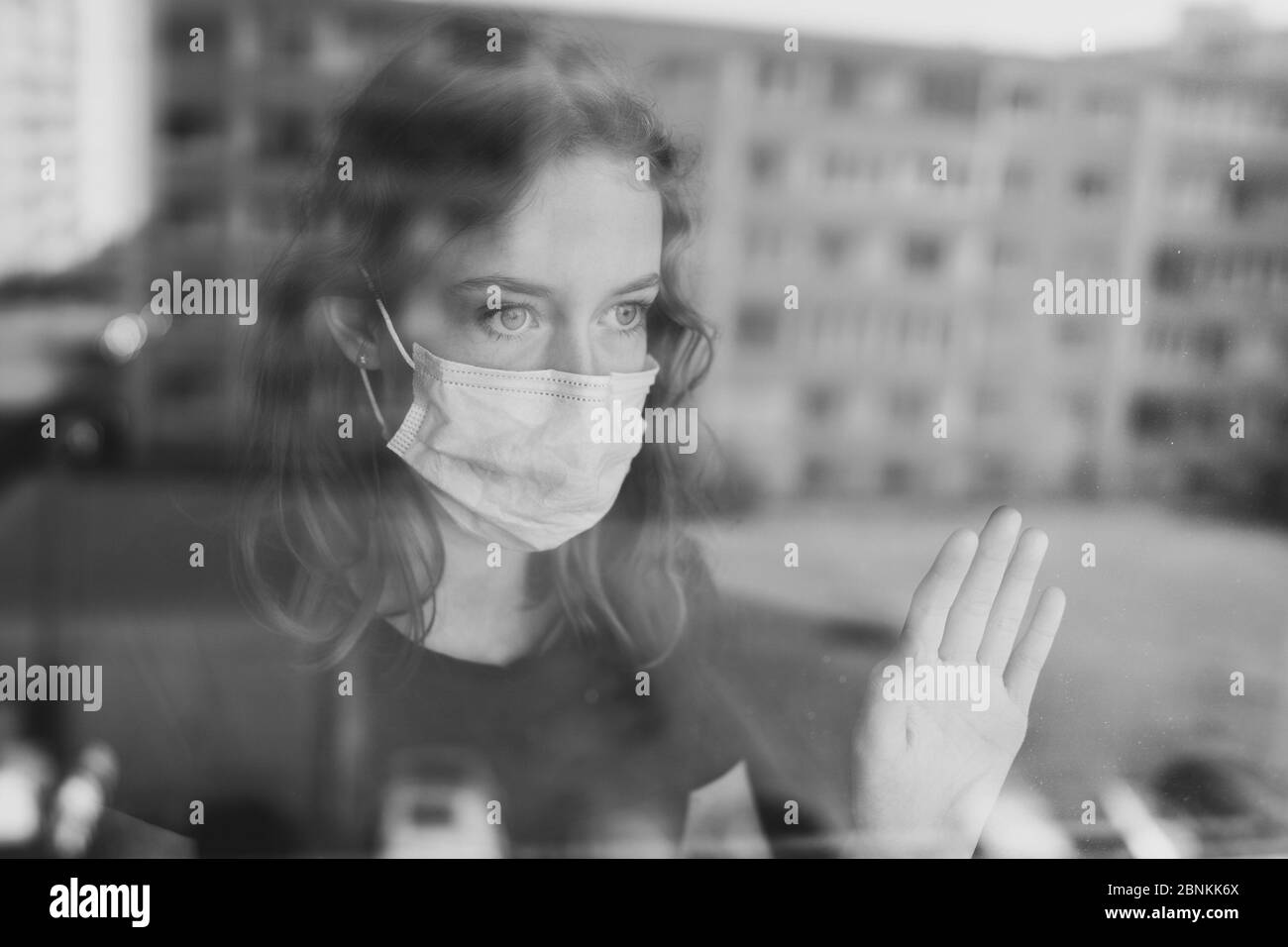 Little girl behind the window during self isolation. Stay home. Black ...