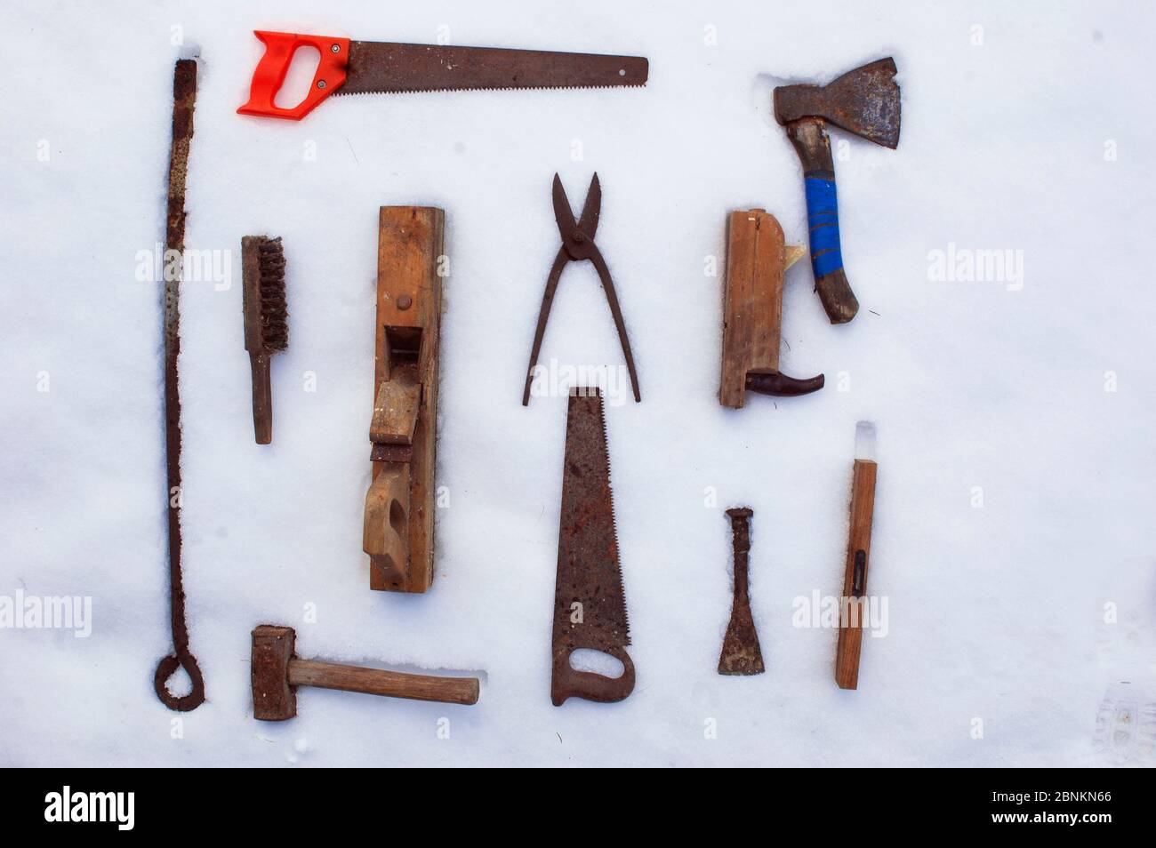 Collection of handtools placed on the snow, overhead shot Stock Photo ...