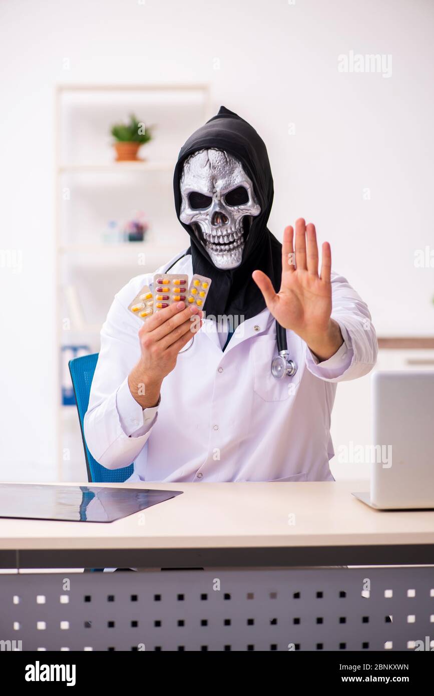 Male devil doctor working in clinic Stock Photo - Alamy