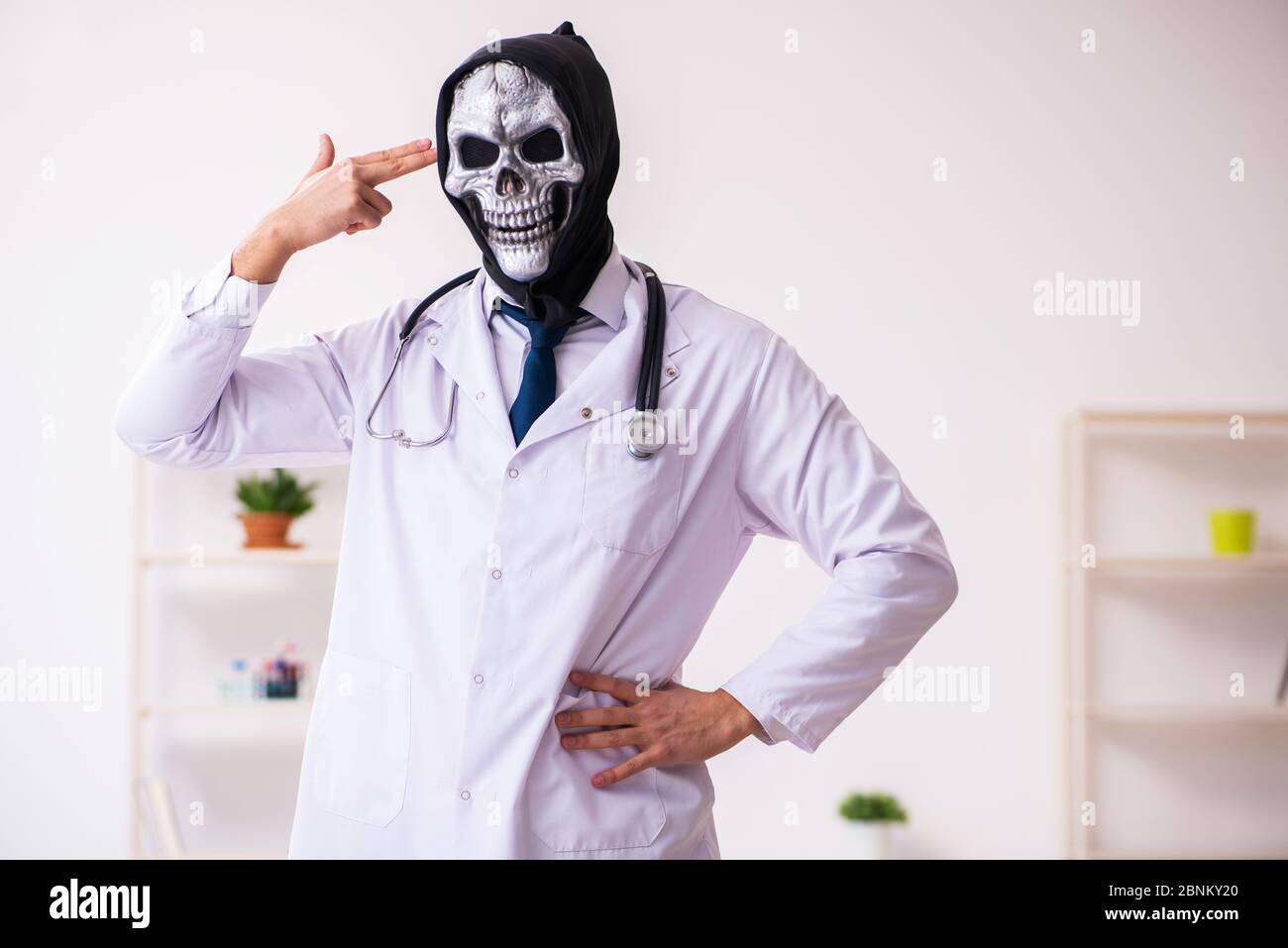 Male devil doctor working in clinic Stock Photo - Alamy