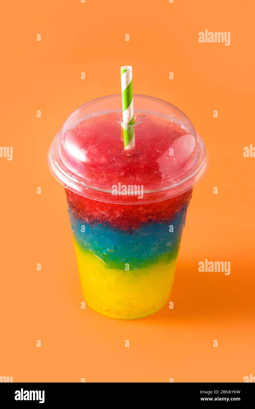 Colorful slushie of differents flavors on orange background Stock Photo ...