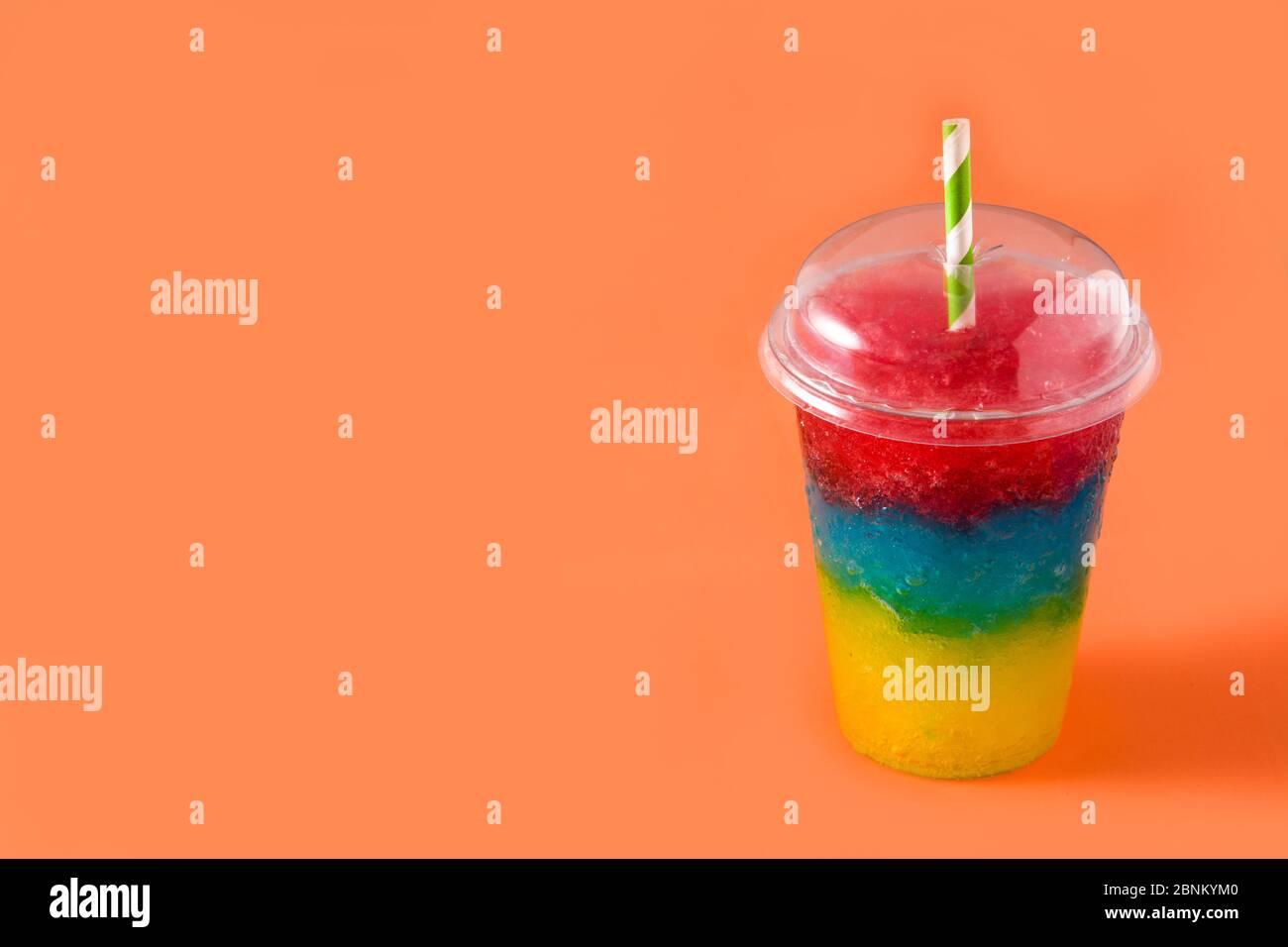 Colorful slushie of differents flavors on orange background Stock Photo ...