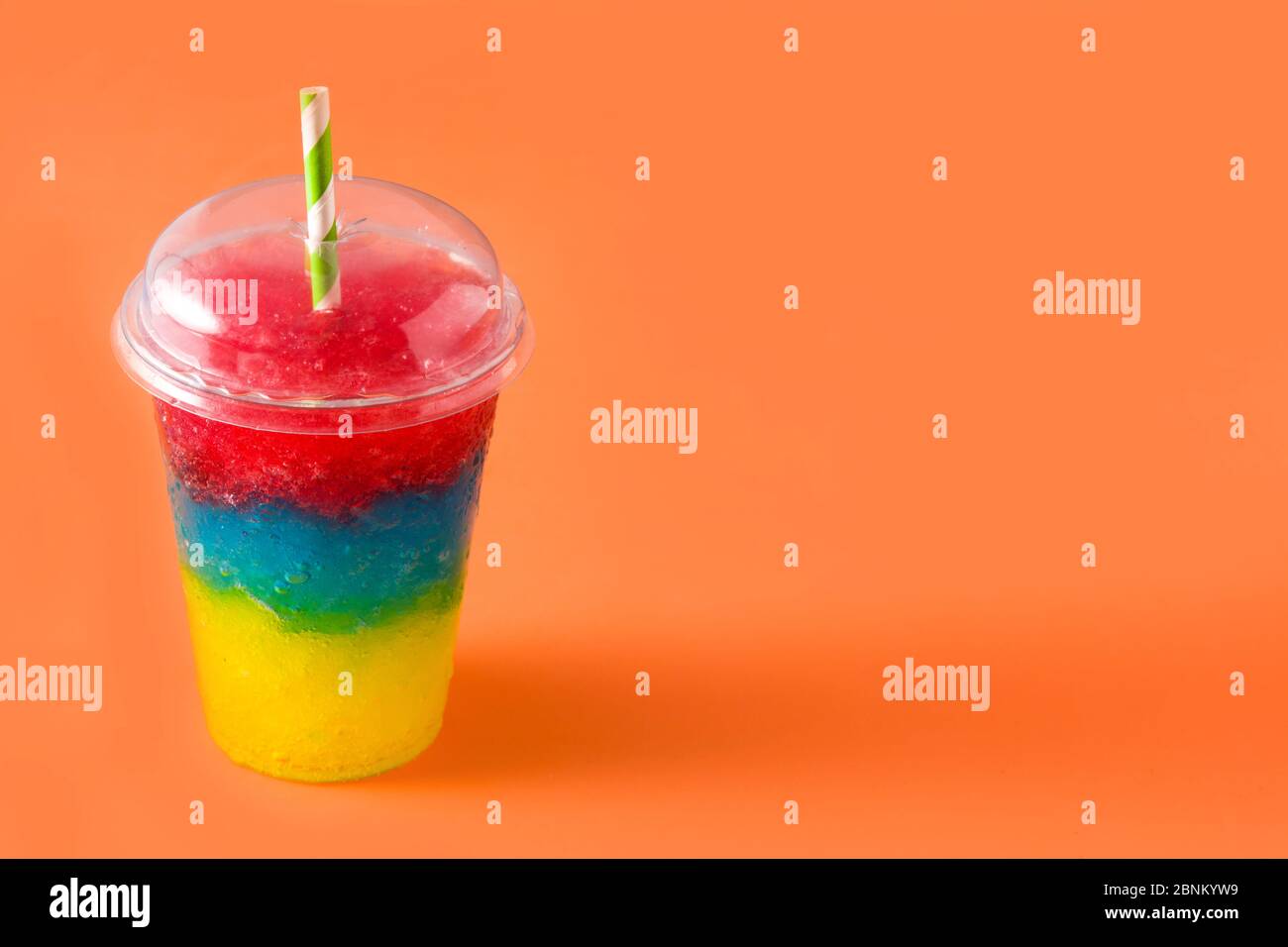Colorful slushie of differents flavors on orange background Stock Photo ...