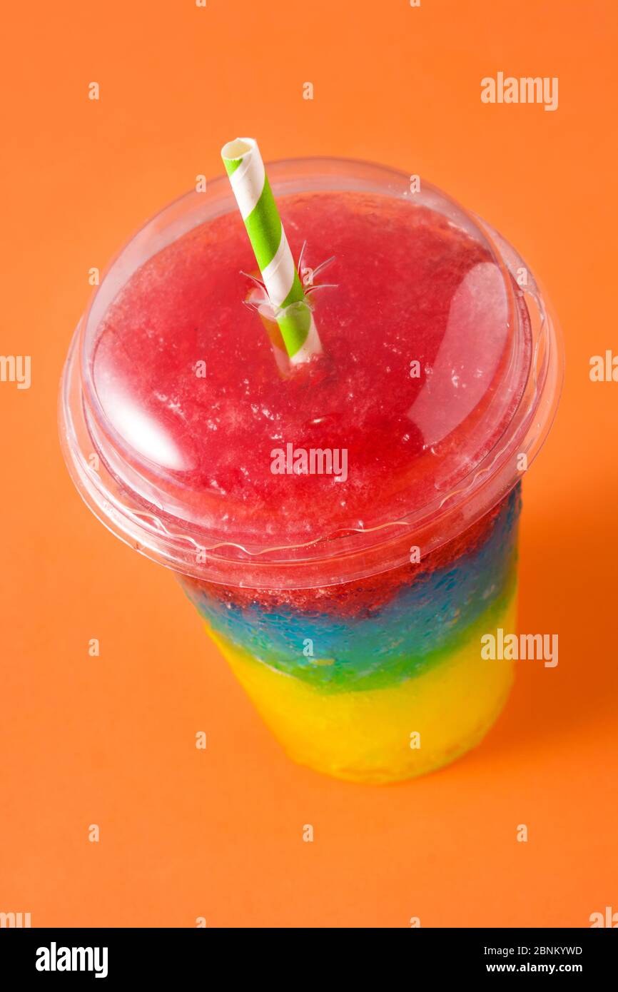 Colorful slushie of differents flavors on orange background Stock Photo ...