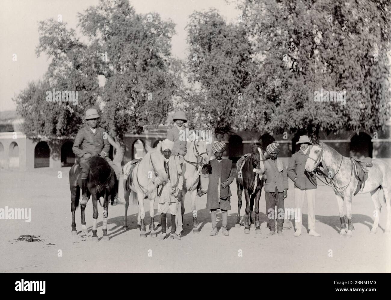 Group of European men with their polo ponies and grooms, India Stock ...