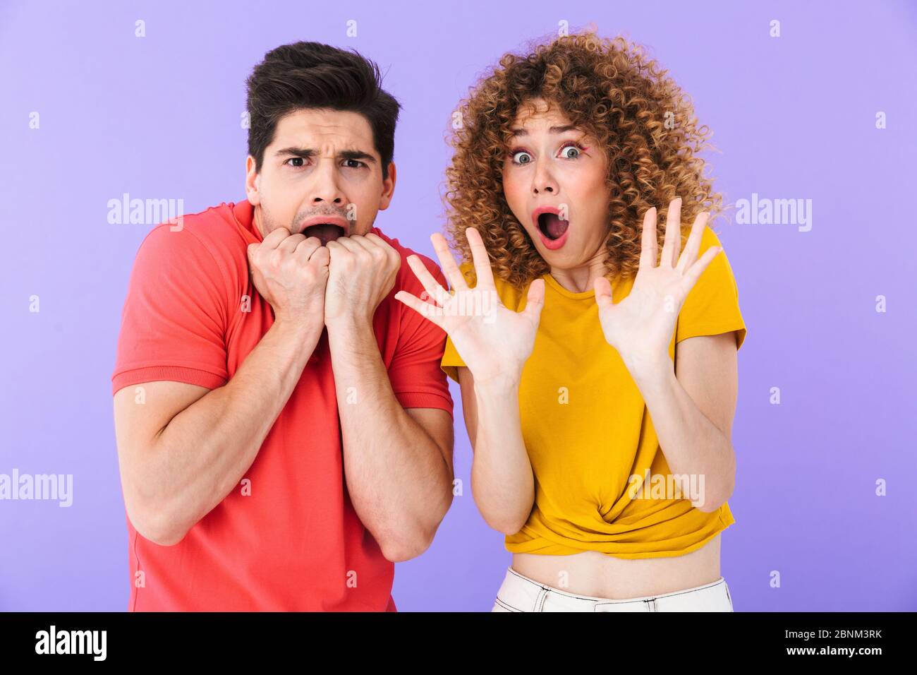 Image of shocked people man and woman in basic clothing expressing fear ...