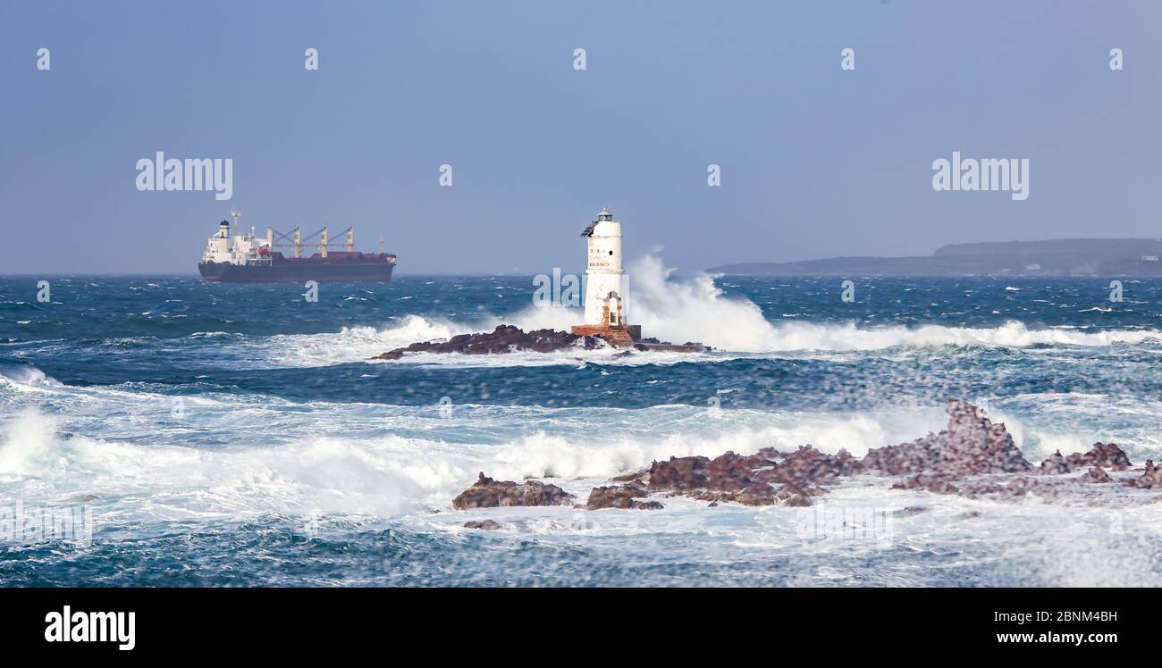 The lighthouse of the Mangiabarche shrouded by the waves of a mistral ...