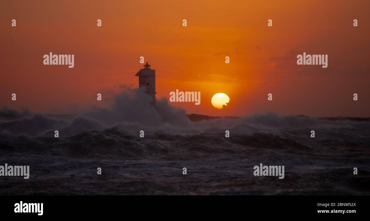 The lighthouse of the Mangiabarche shrouded by the waves of a mistral ...