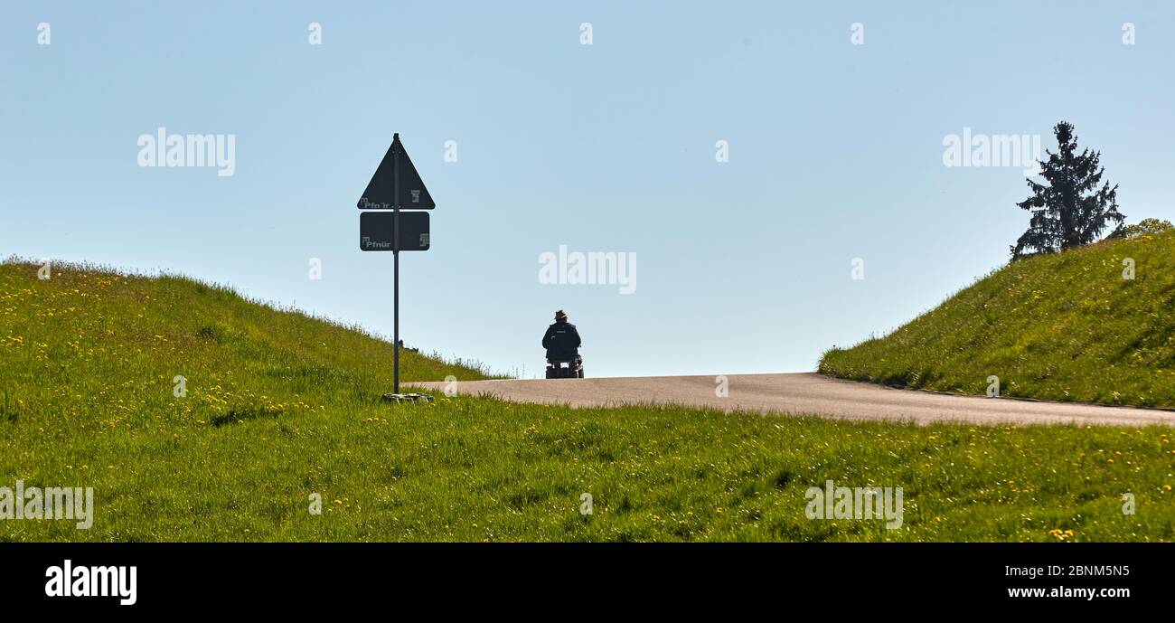 Wheelchair user, street, hilltop, traffic sign Stock Photo - Alamy