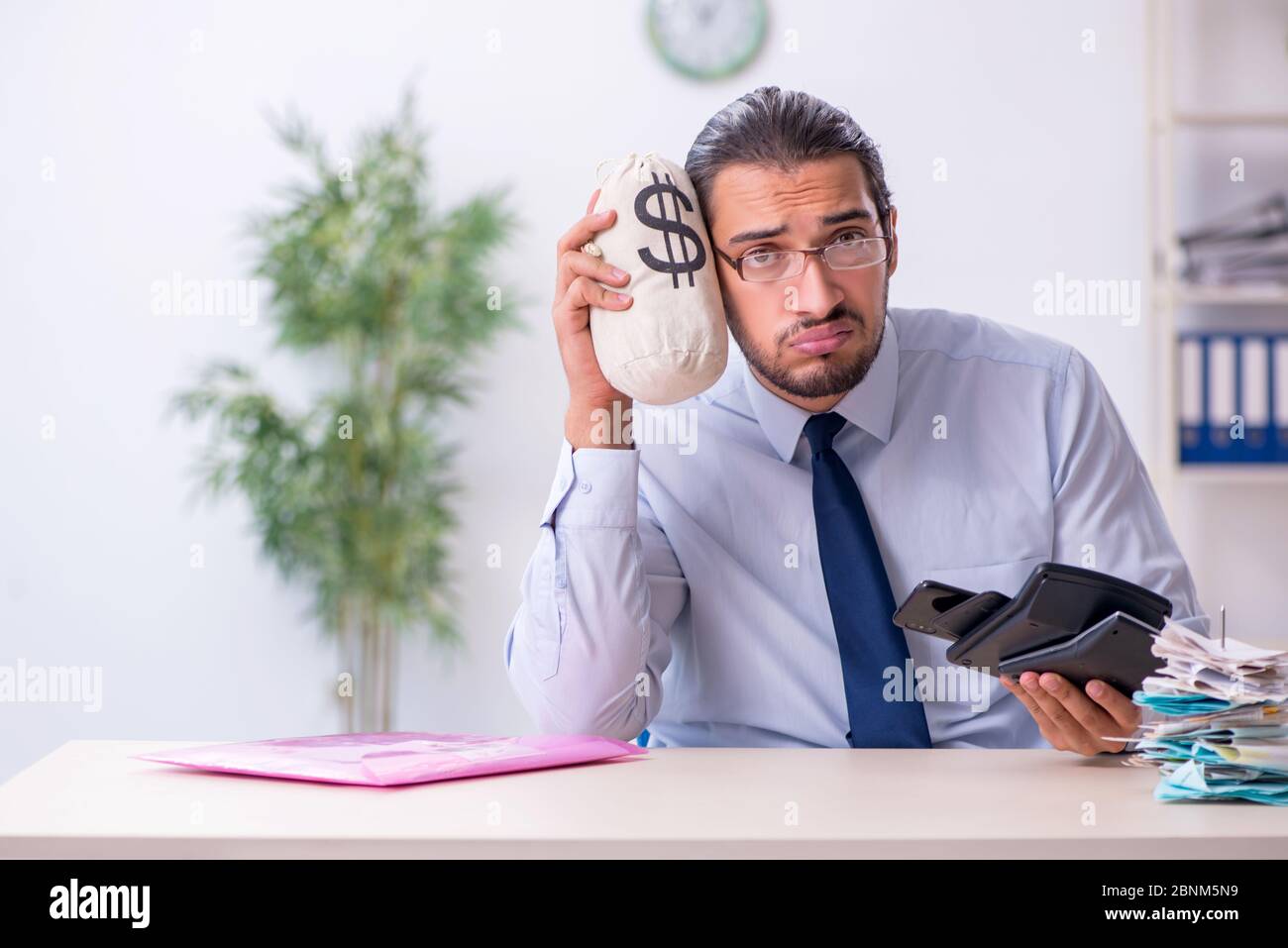 Young employee in budget planning concept Stock Photo - Alamy