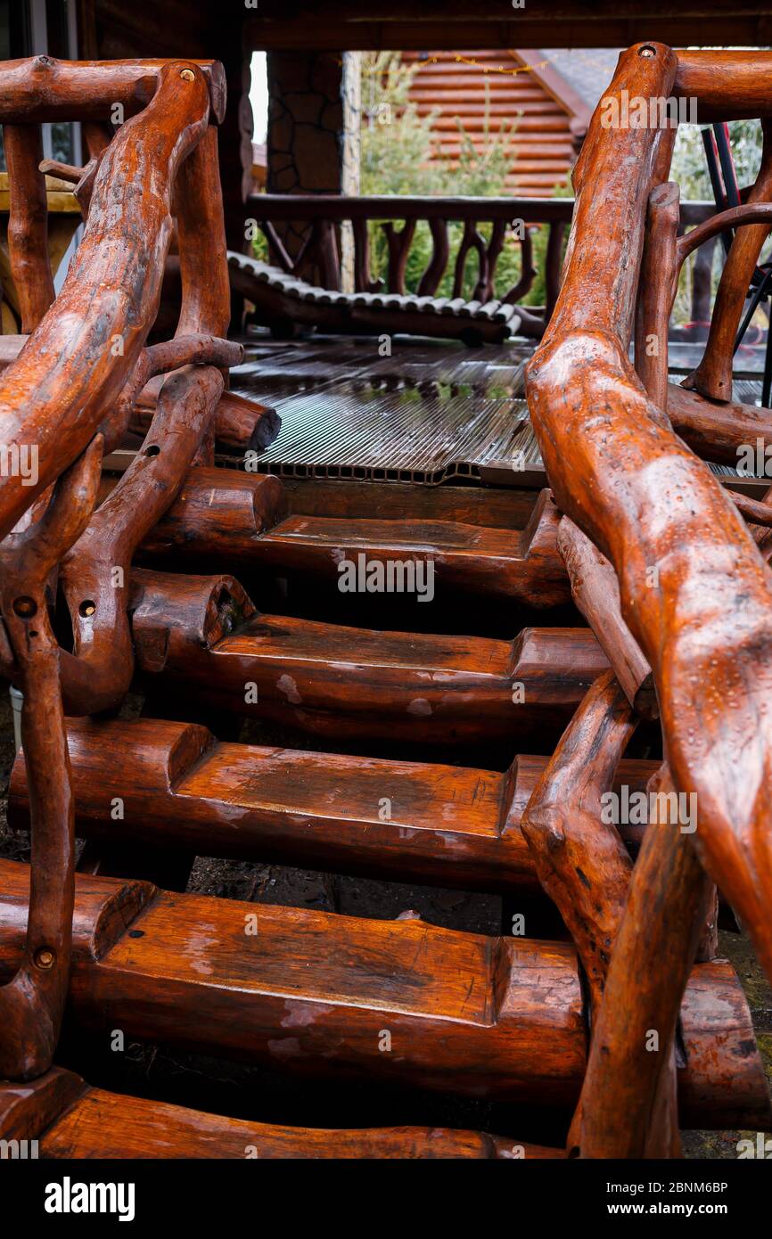 Wooden steps to the terrace. Staircase from a log house on the street ...