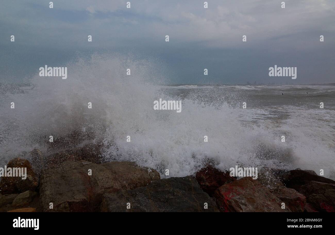 The breaking of the waves on the beach. Storm colors Stock Photo - Alamy