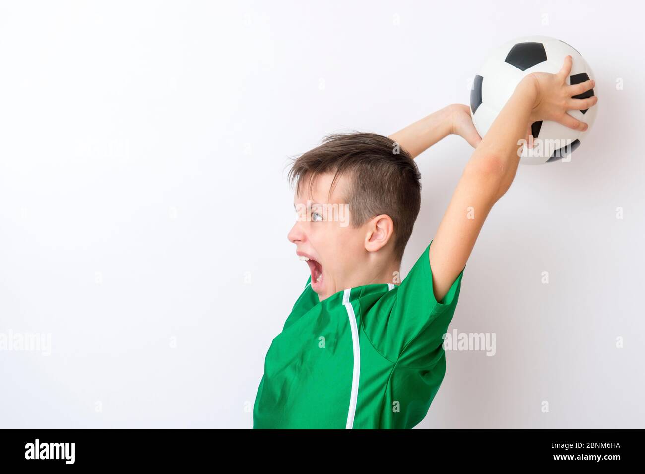 Kid play with soccer ball over white background. Kid activities ...