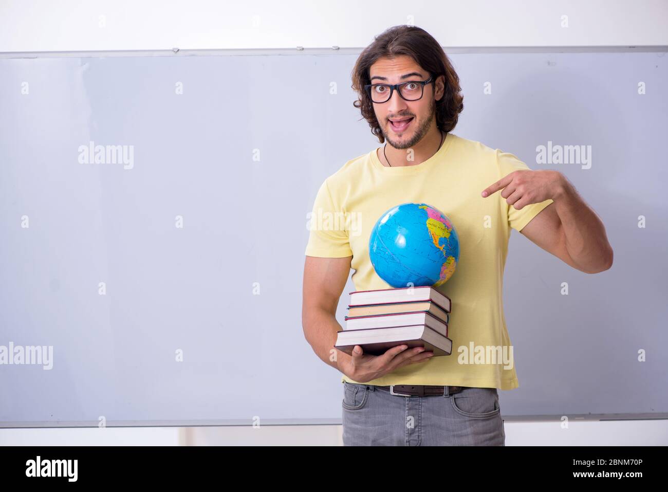 Young geography teacher explaining lesson hi-res stock photography and ...