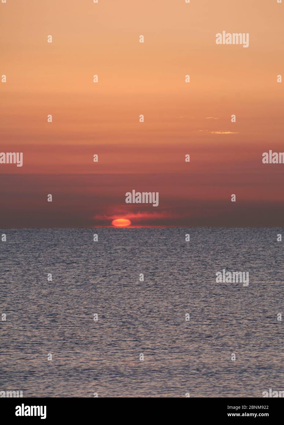 Sunrise on the beach with the sun rising. Colors of nature Stock Photo ...