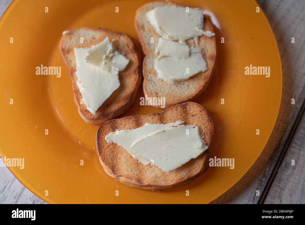 Fried slice of toast with butter top view. Fried bread with butter ...