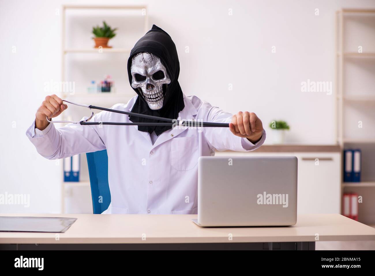 Male devil doctor working in clinic Stock Photo - Alamy