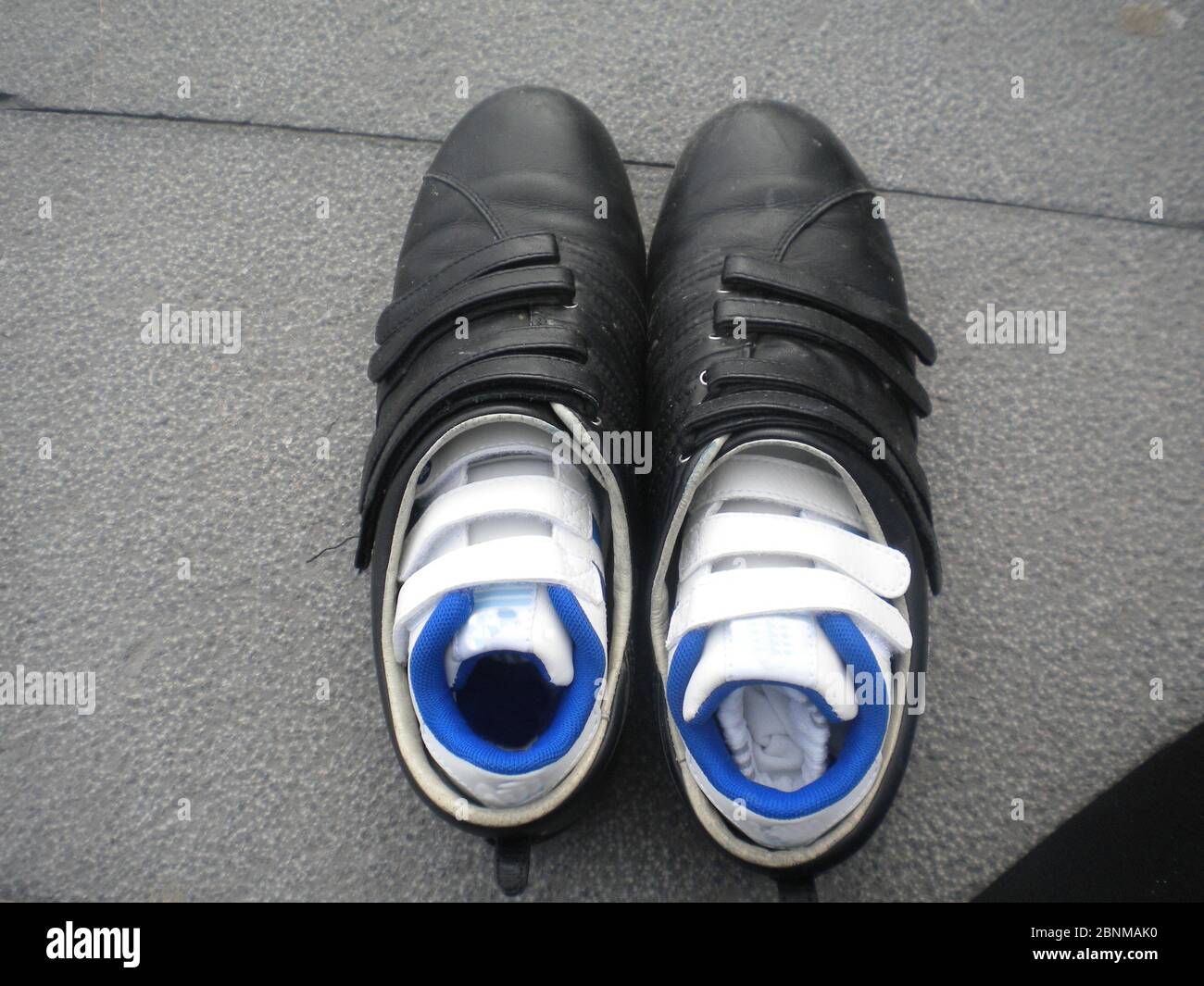 White sneakers inside black sneakers, love. Mother and son Stock Photo ...