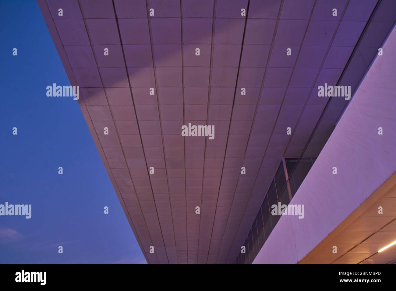 Modernist building roof in blue sky, parallel lines, symmetry ...