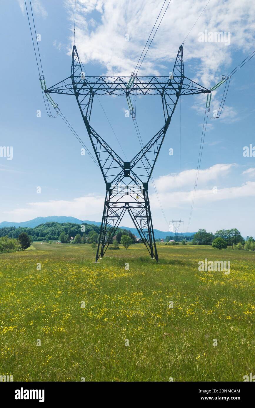 High voltage transmission power line tower in the middle of spring ...