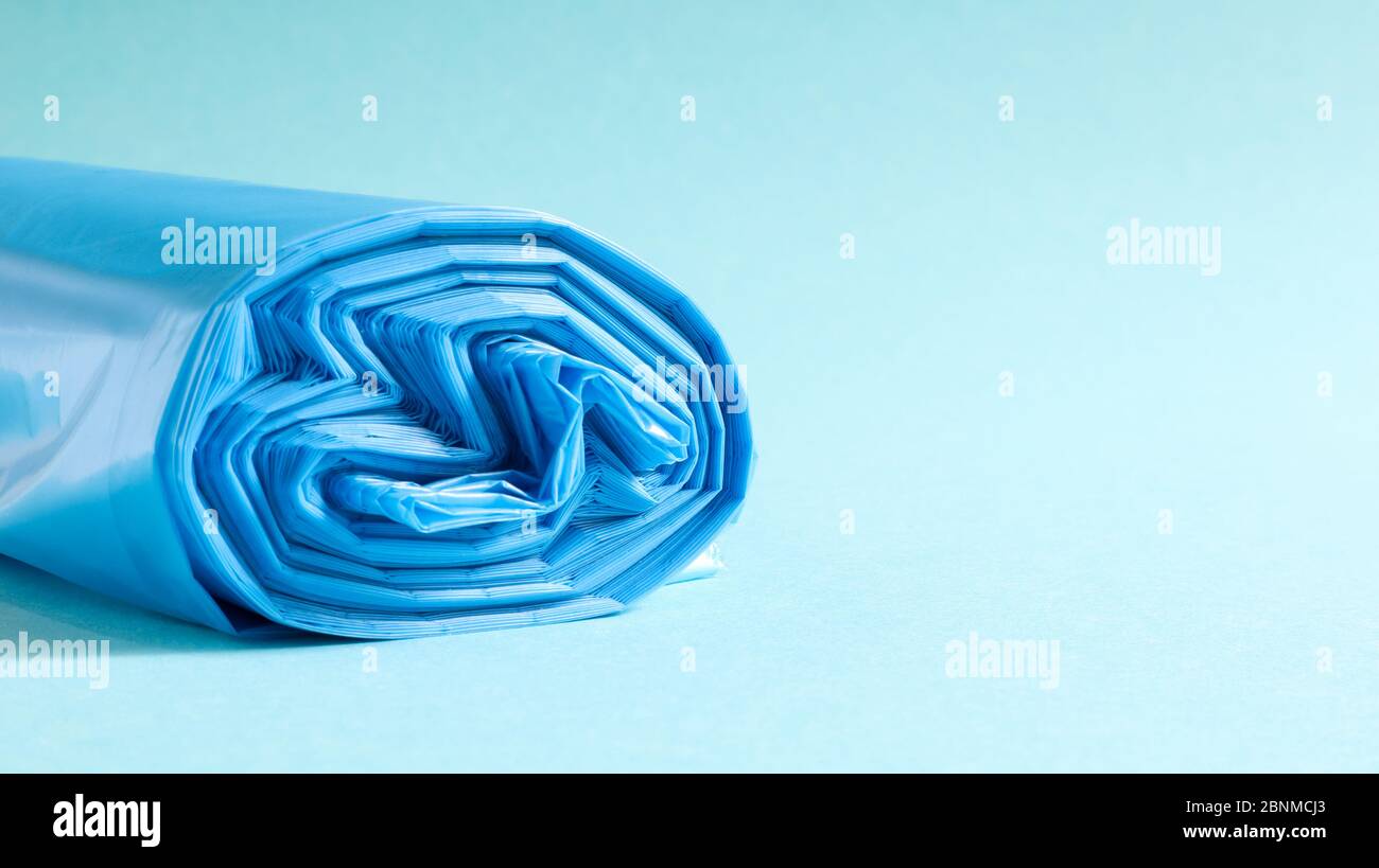 One roll of plastic trash bags in blue on a blue background. Bags that ...