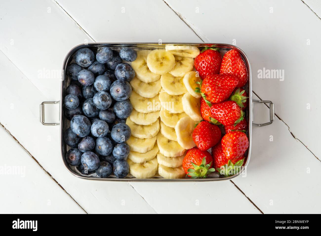 Blueberries, bananas and strawberries snack in a big stainless steel ...