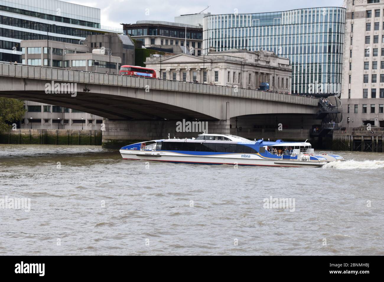 A cruise boat in The River Thames, London, England, UK just about to go ...